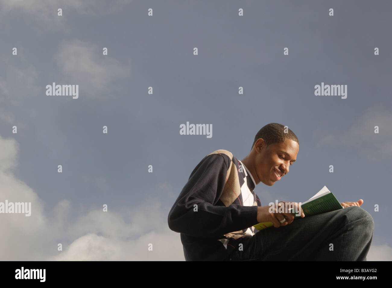 African man reading outdoors Stock Photo - Alamy