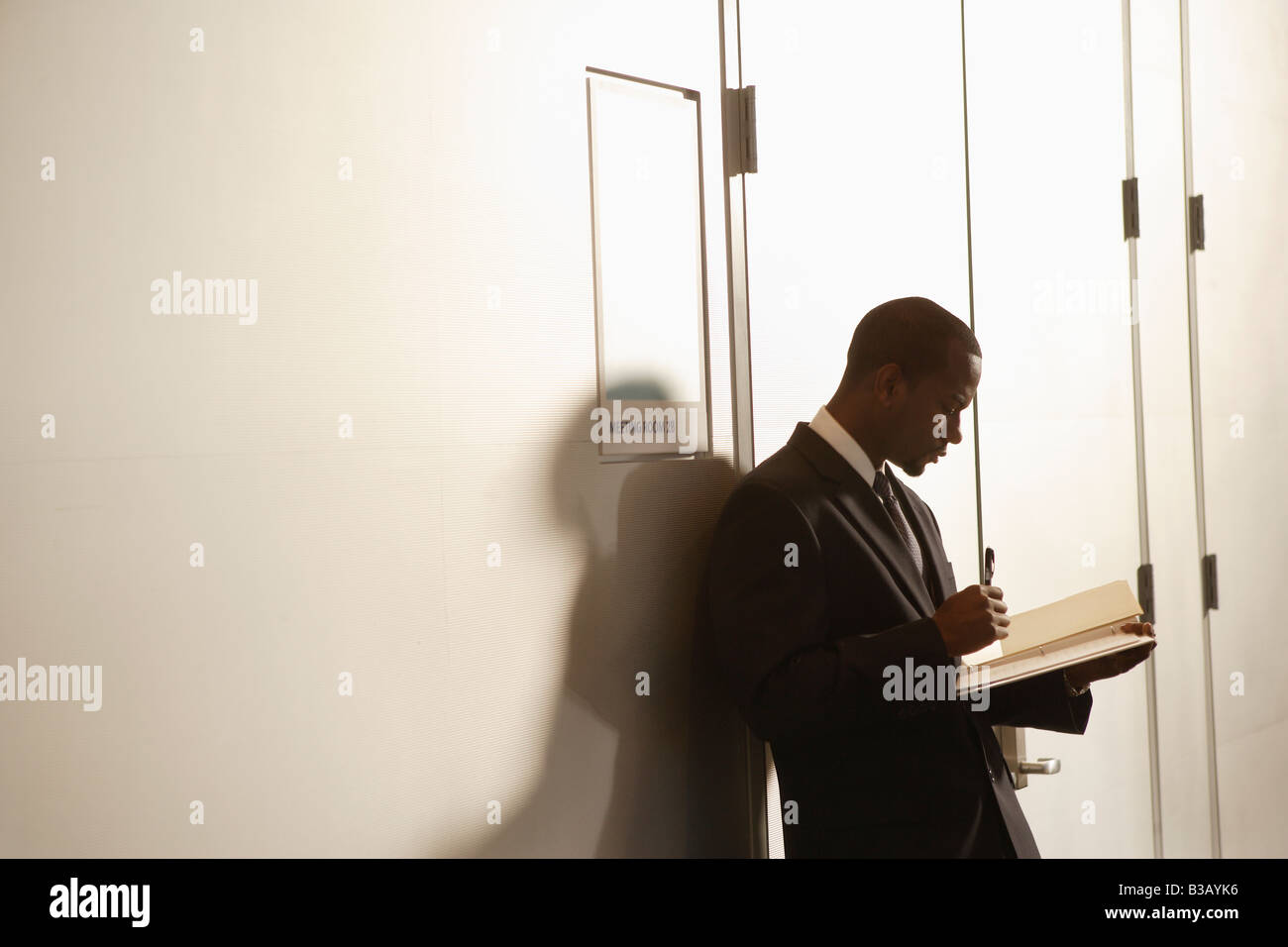 African American businessman looking at paperwork Stock Photo - Alamy