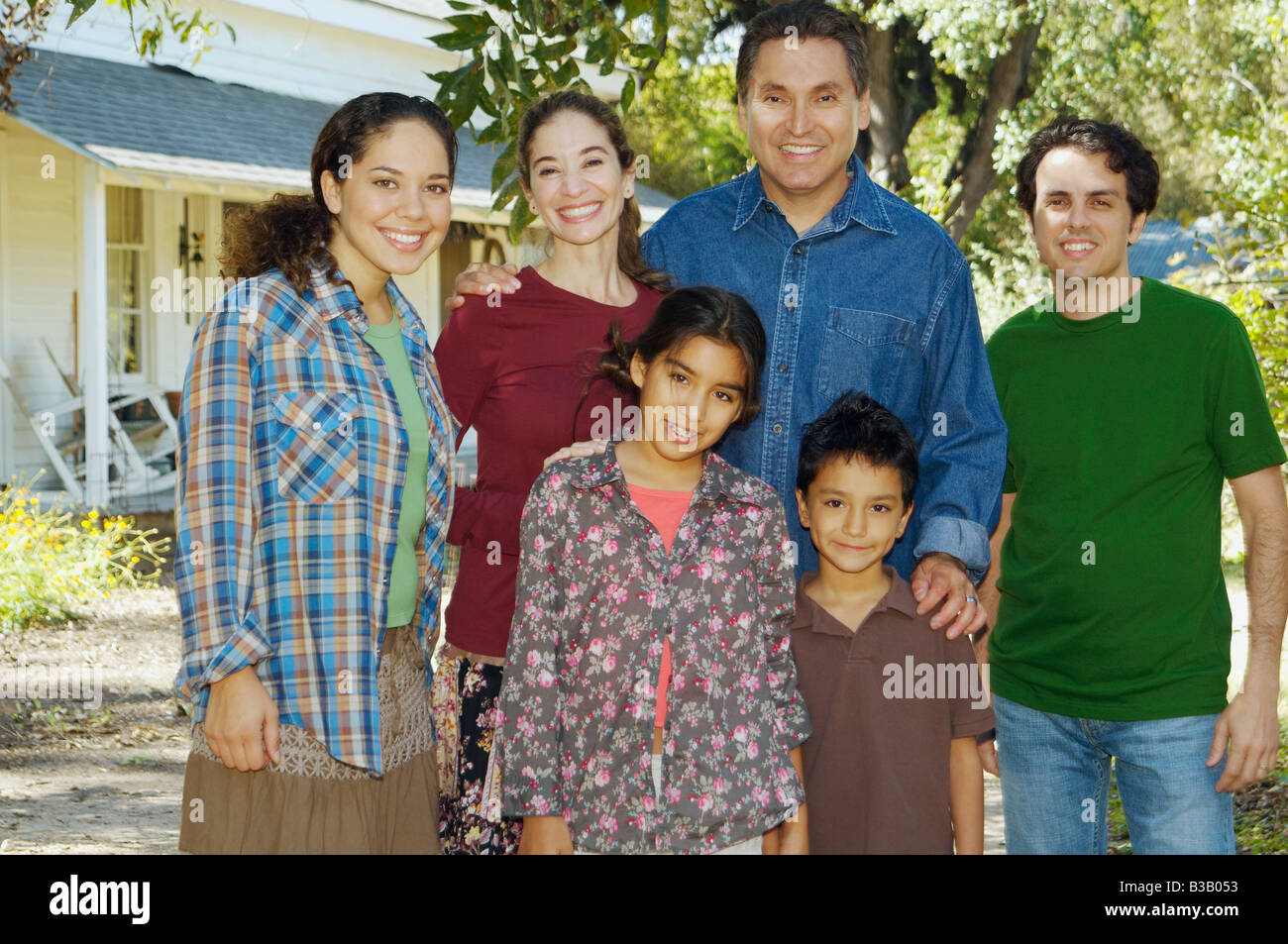 Multi-ethnic family in front of house Stock Photo - Alamy