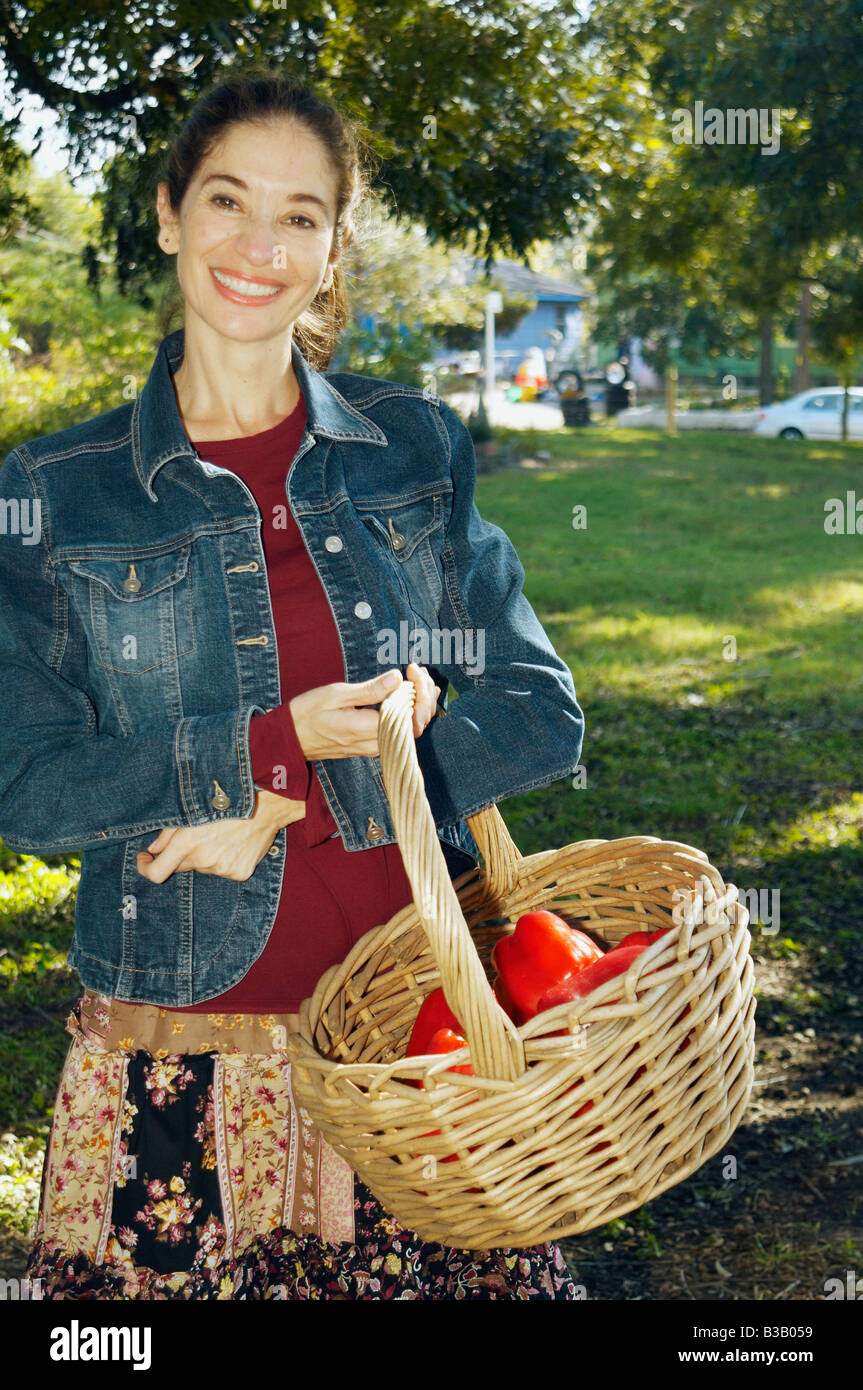 Middle Eastern woman carrying basket of organic produce Stock Photo - Alamy