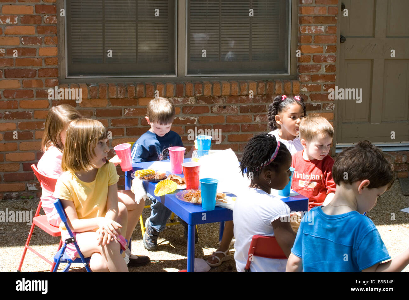 Birthday Party Eating Cookies and Cake Outside Stock Photo - Alamy
