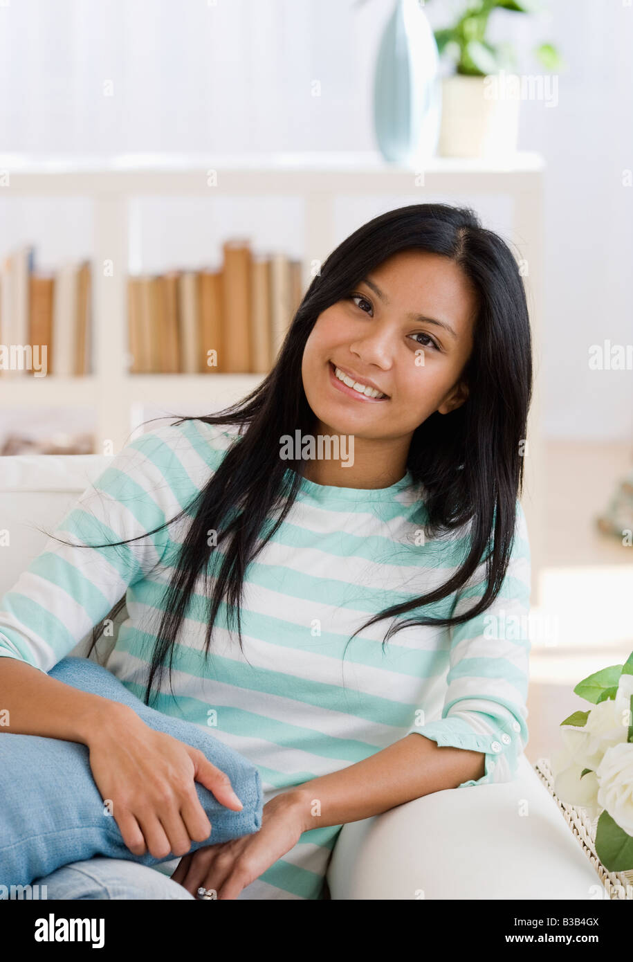 Casual woman sitting on sofa hi-res stock photography and images - Alamy