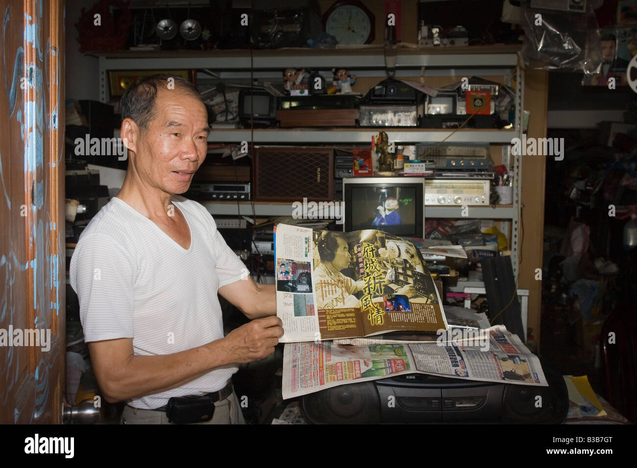 Retired Taiwanese Chinese radio engineer with old magazine featuring ...