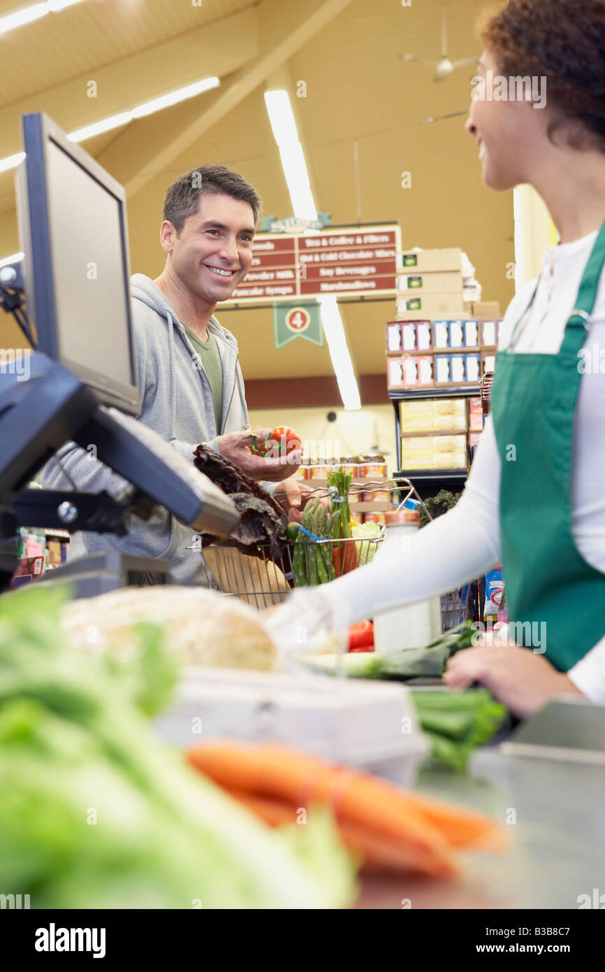 Hispanic man checking out at grocery store Stock Photo - Alamy