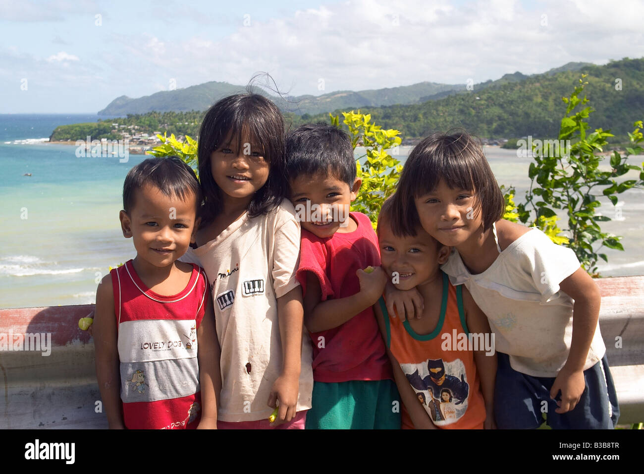 Happy smiling Filipino children at a viewpoint over picturesque bay at ...