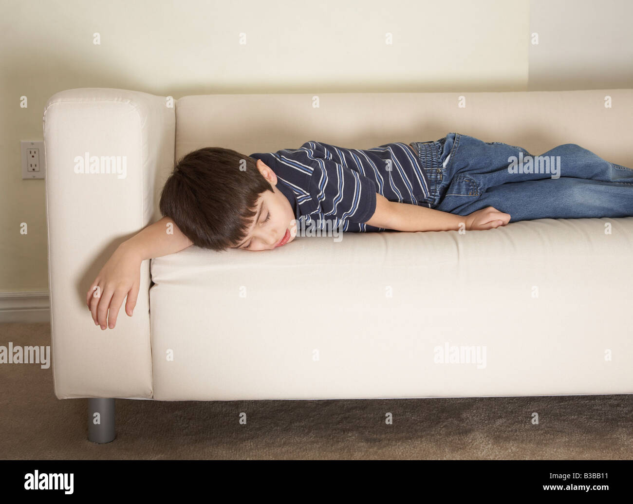 Boy Napping on Sofa Stock Photo - Alamy