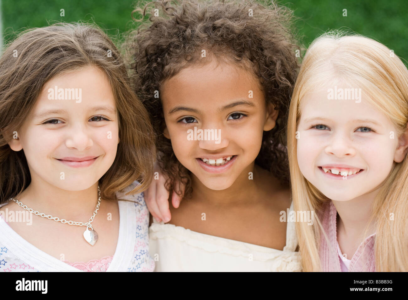 Close up of multi-ethnic girls smiling Stock Photo - Alamy