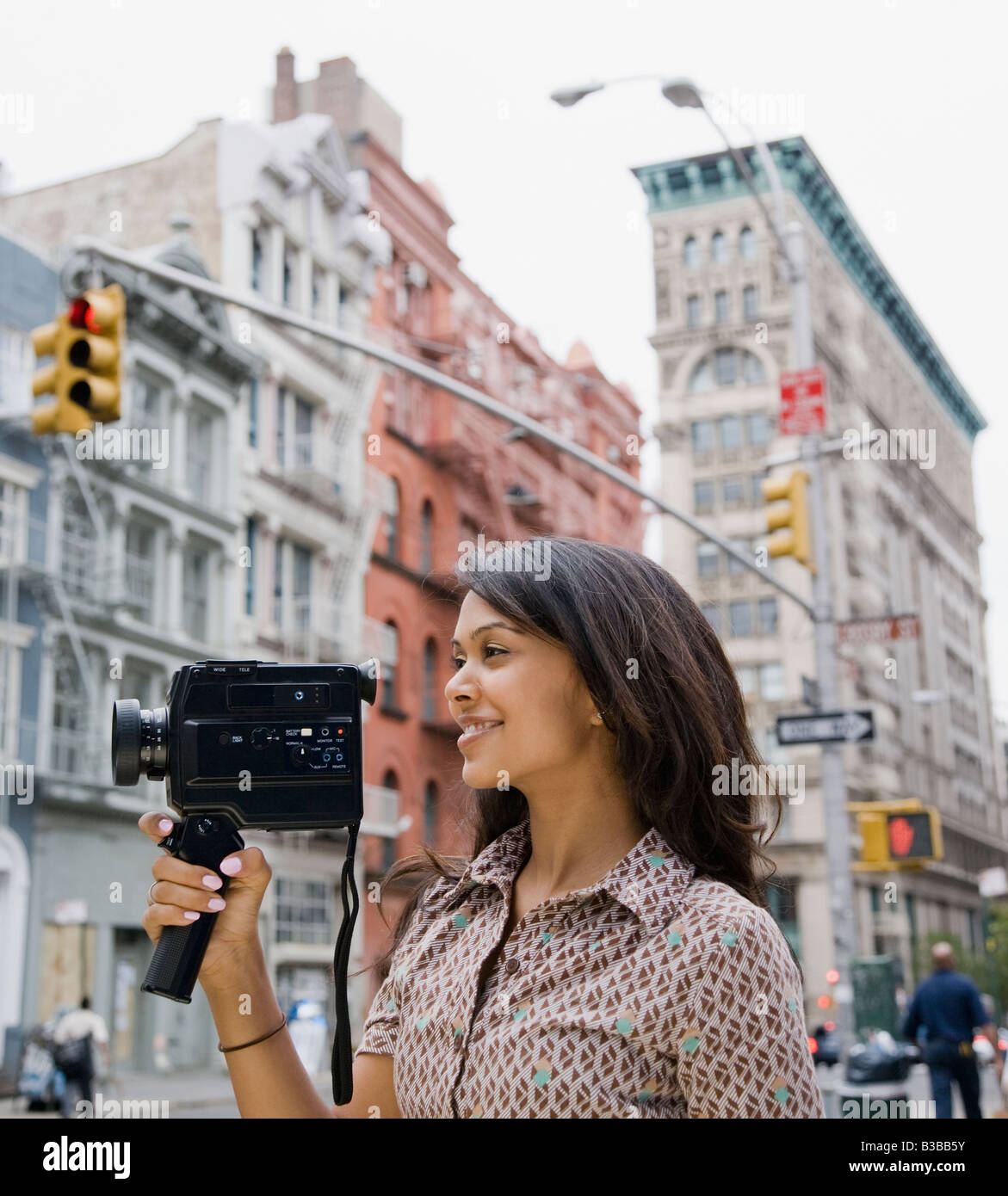 Mixed Race woman holding video camera Stock Photo - Alamy