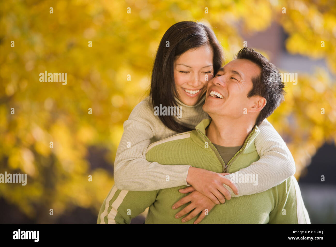 Asian woman hugging boyfriend Stock Photo - Alamy