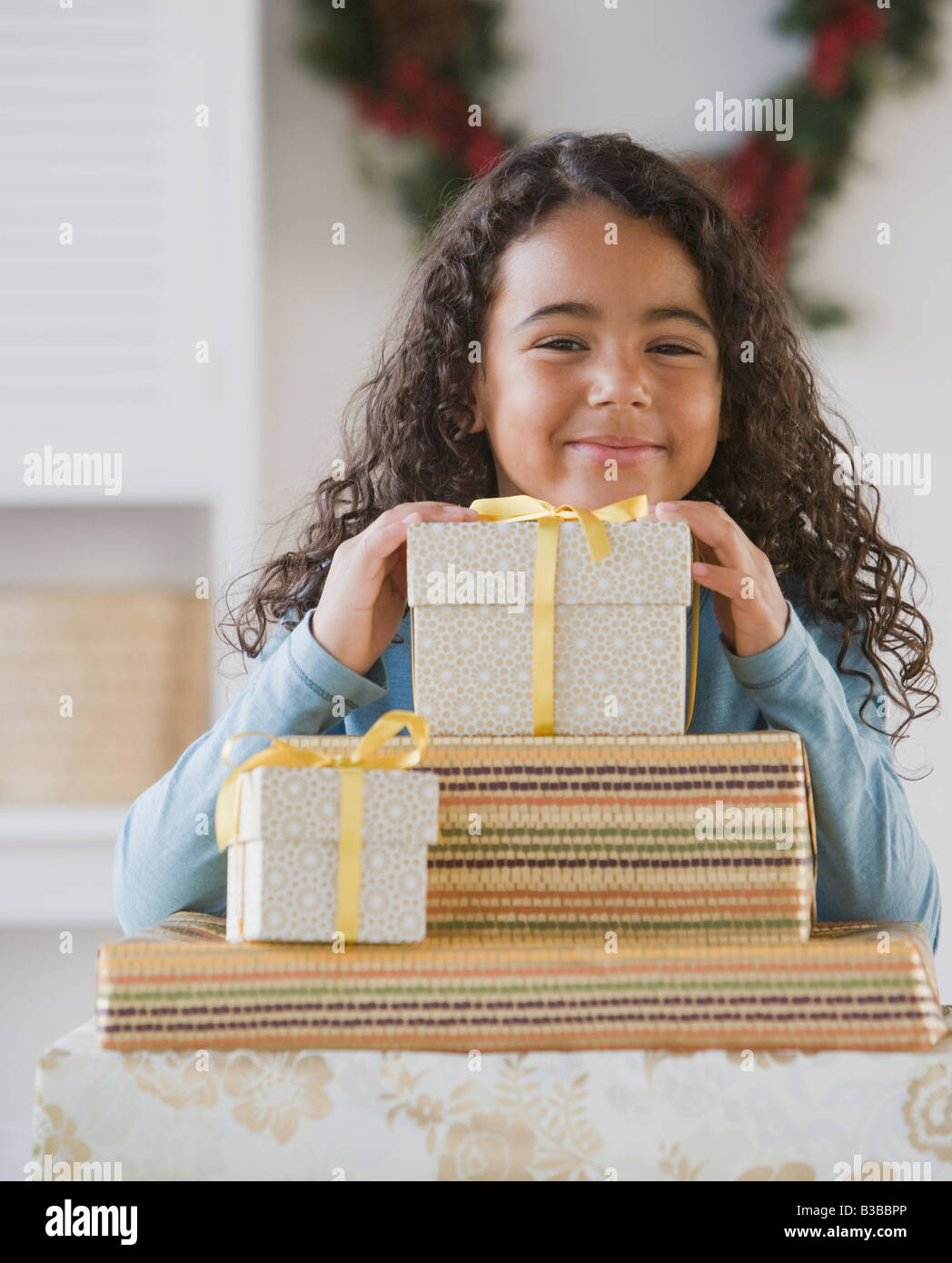 African girl behind stack of gifts Stock Photo - Alamy