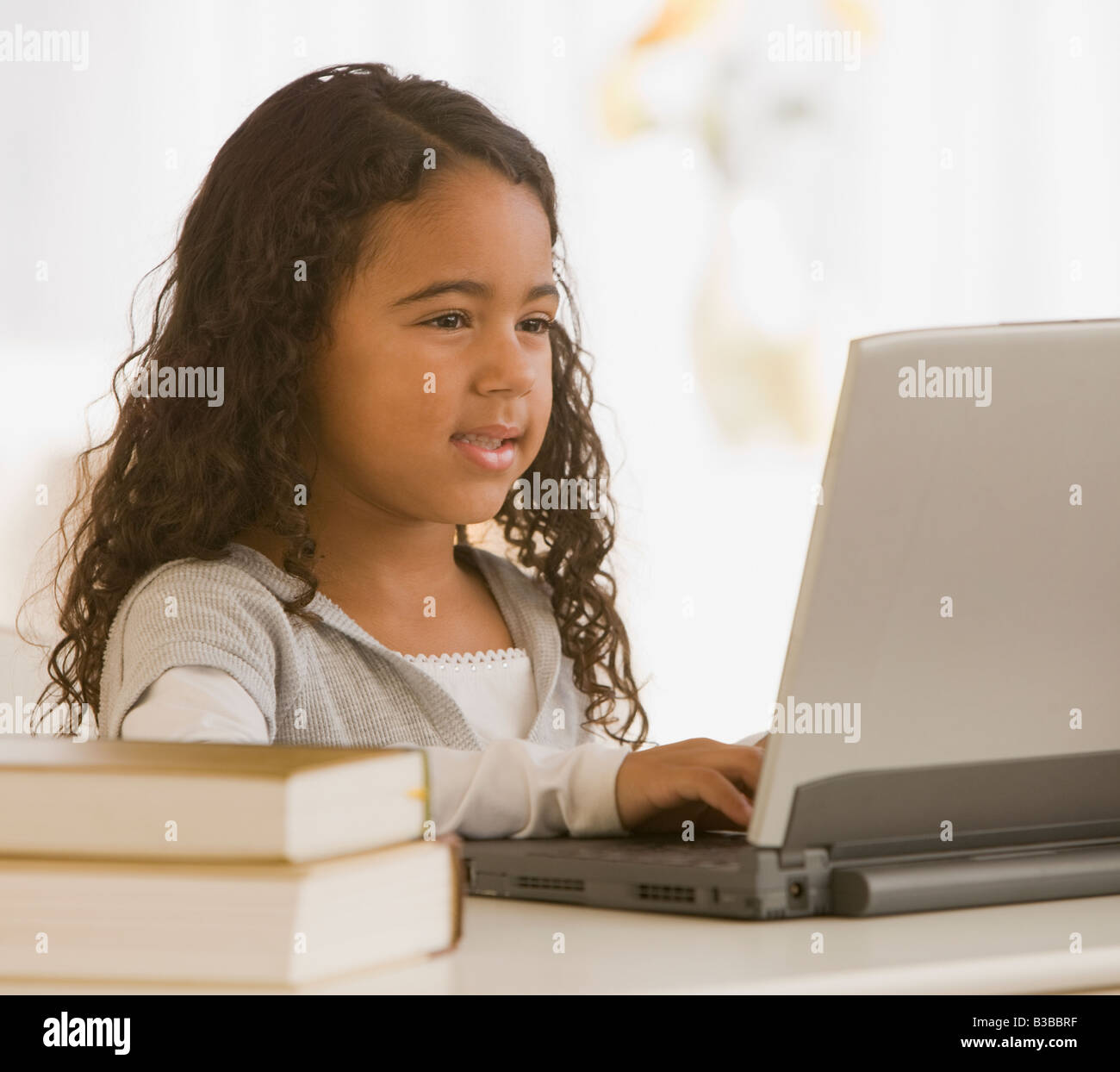 African girl typing on laptop Stock Photo - Alamy
