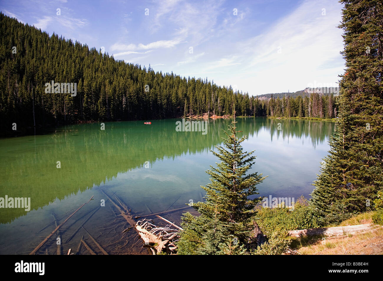 USA OREGON CASCADE MOUNTAINS A canoe and a view of Devil s Lake along ...