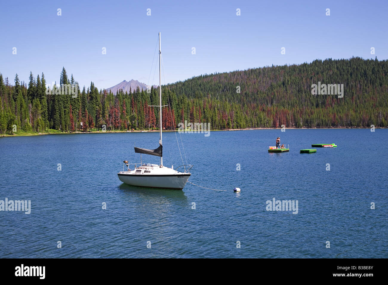 A sailboat and a view of Elk Lake along the Cascade Lakes Highway near ...