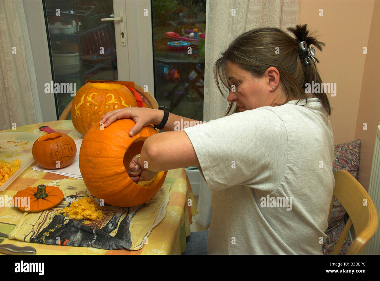 Woman Hollowing Out A Pumpkin For Halloween Stock Photo - Alamy