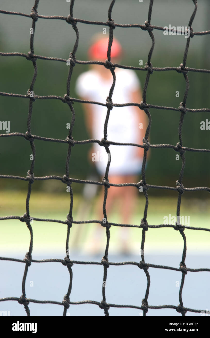 Tennis Player Out of Focus Behind Net on Court Stock Photo - Alamy