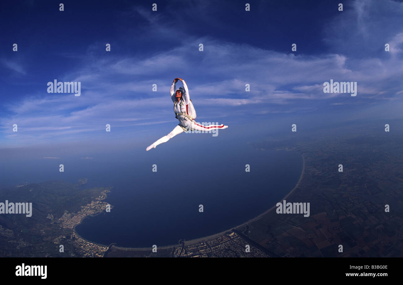 Female Freestyle skydiver performs a beautiful pose above the spanish ...
