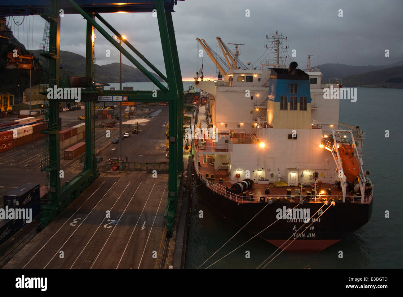 A bulk carrier alongside the quay at dawn in Lyttelton, New Zealand ...
