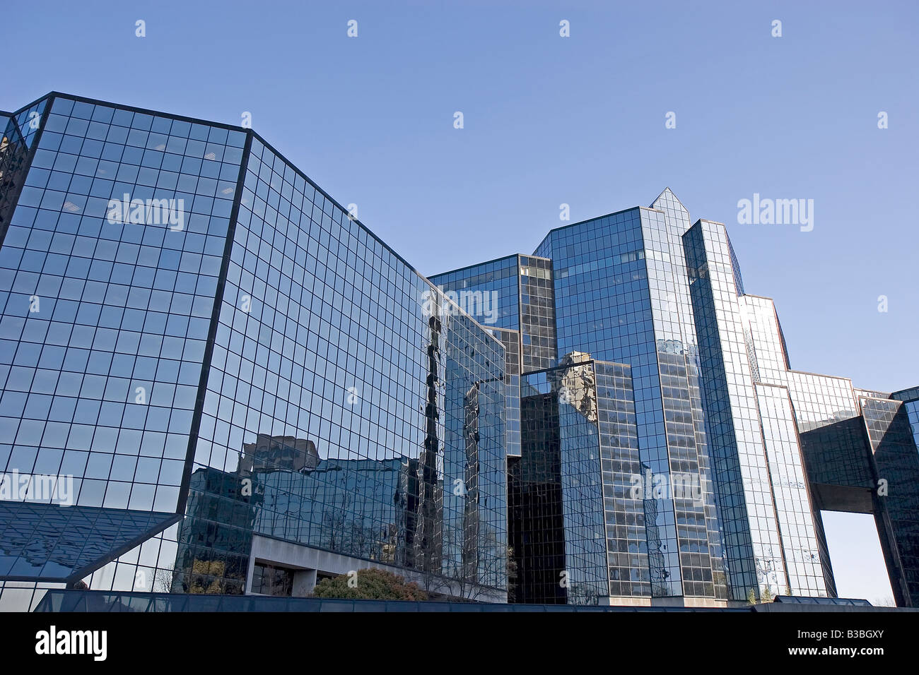 A massive blue glass financial center reflecting the city skyline Stock ...