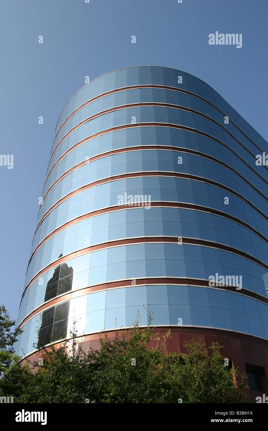A round glass office building reflecting surroundings Stock Photo - Alamy