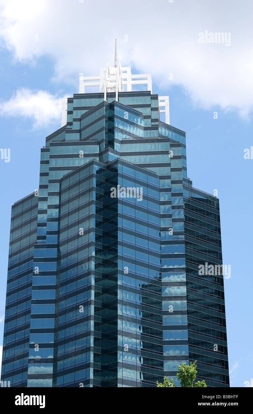 A modern blue office tower rising into clouds Stock Photo - Alamy