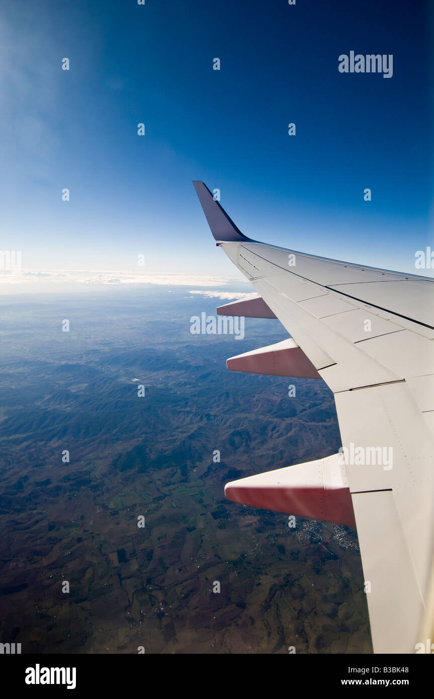 Looking out an aircraft window at the wing of a boeing 737 800 at a ...