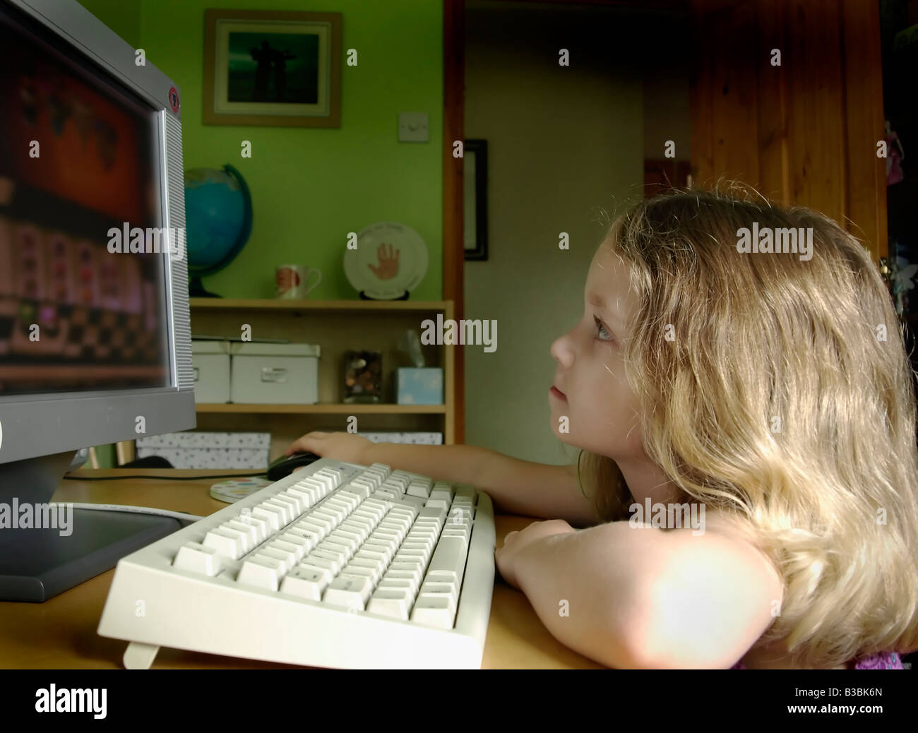 Female child age 4 using a computer domestic environment Stock Photo ...