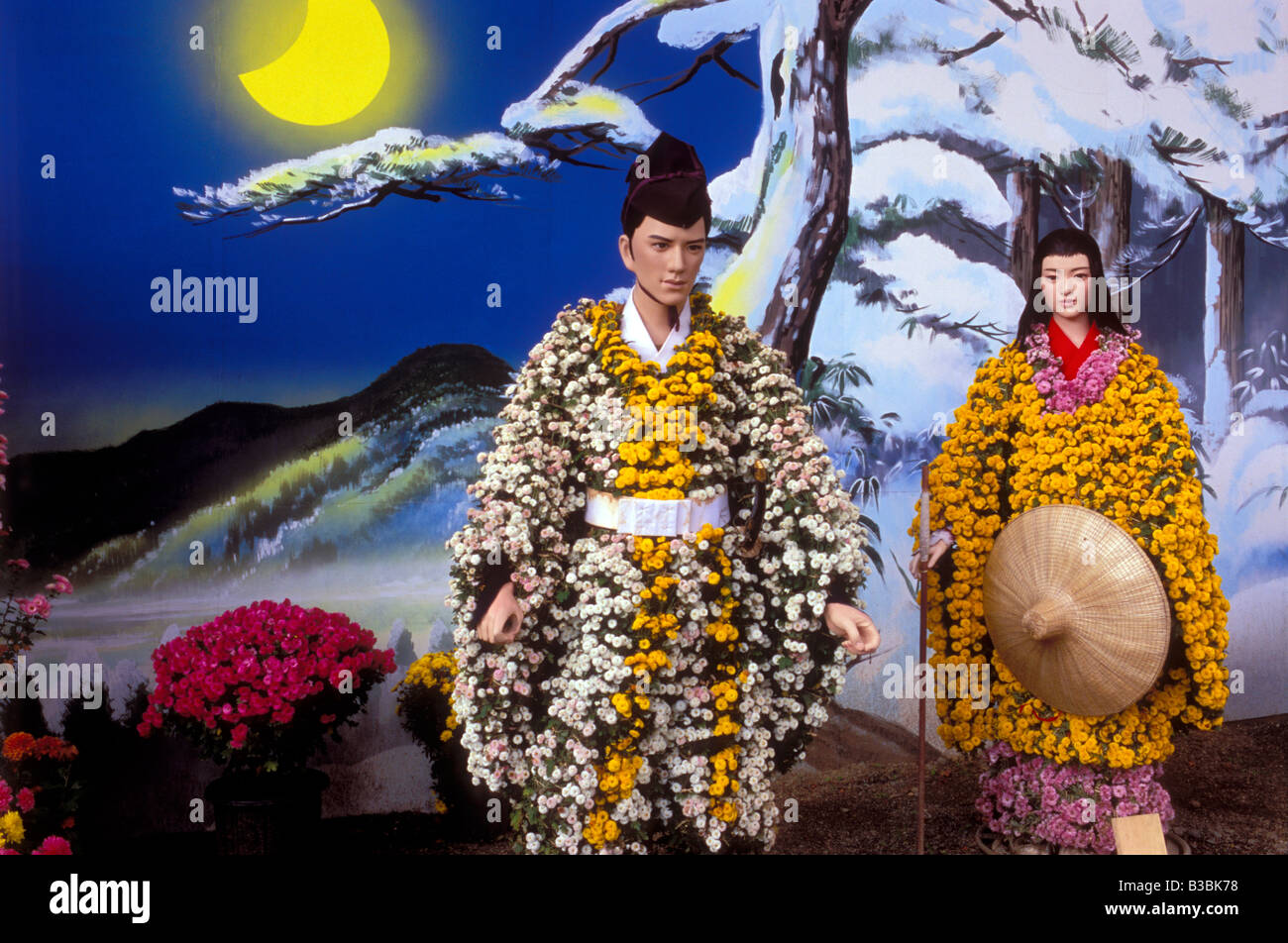 Thousands of chrysanthemum flowers adorn traditional mannequins in an ...