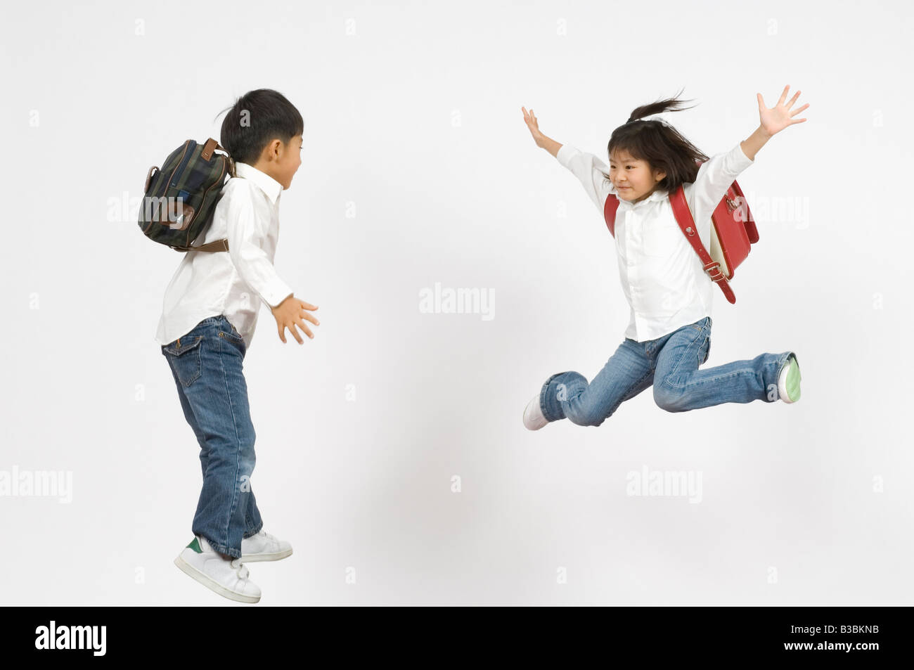 Elementary students jumping Stock Photo - Alamy