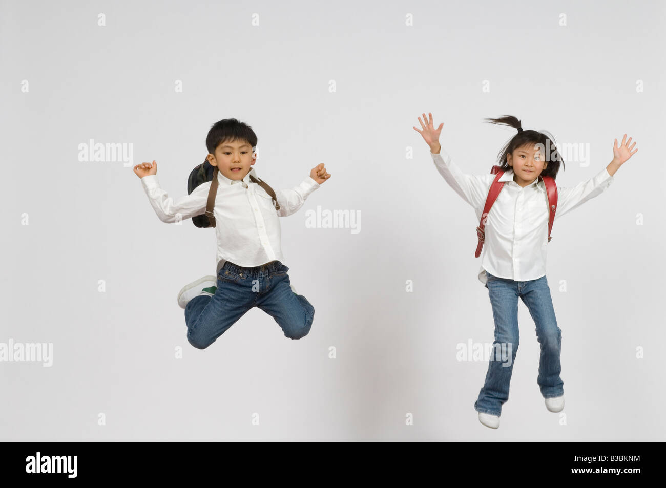 Elementary students jumping Stock Photo - Alamy