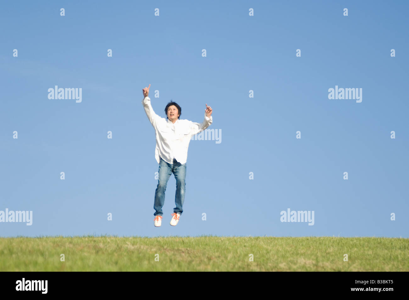Man jumping on grass Stock Photo - Alamy