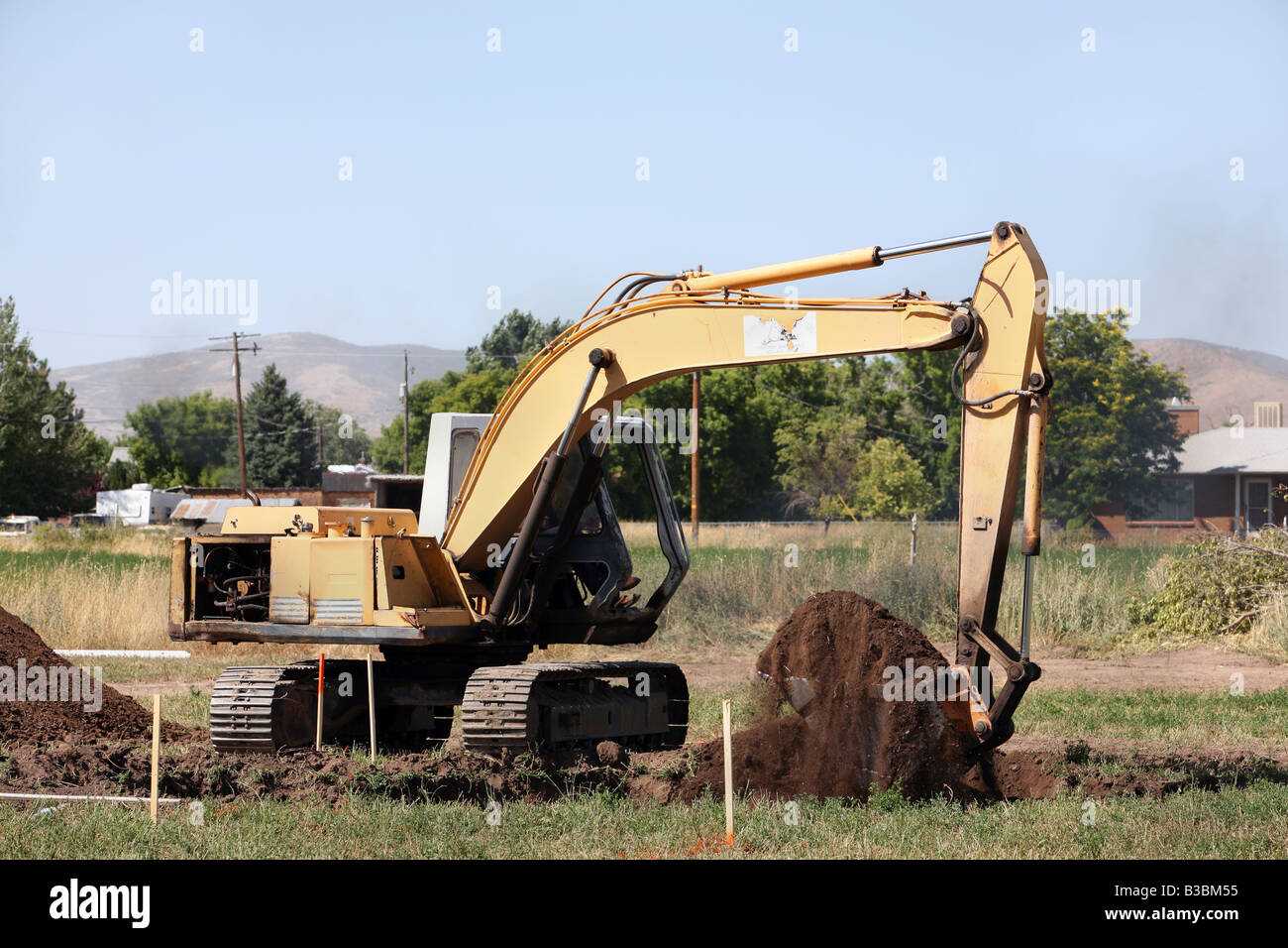 Photo of a large excavator tracked backhoe working and helping to build ...