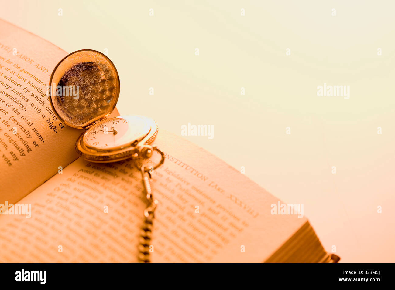 Book and pocket watch Stock Photo - Alamy