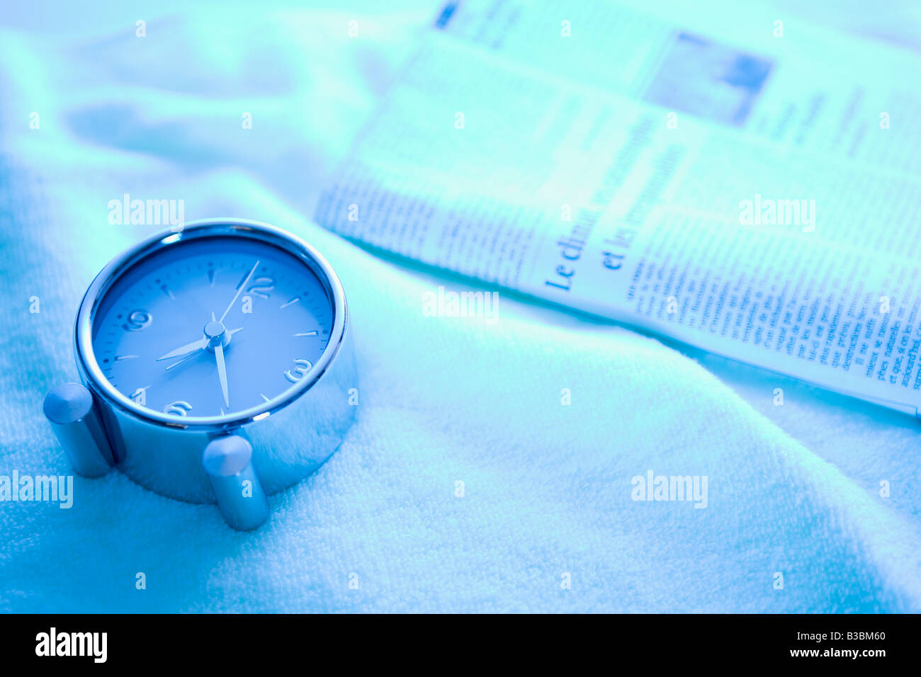 Alarm Clock and Newspaper Stock Photo - Alamy