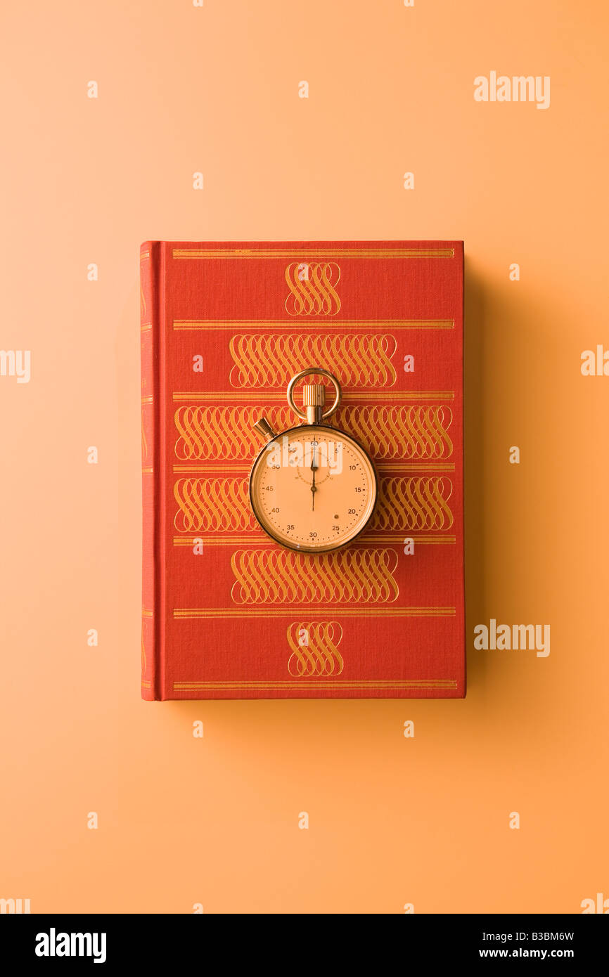 Stopwatch on book Stock Photo - Alamy