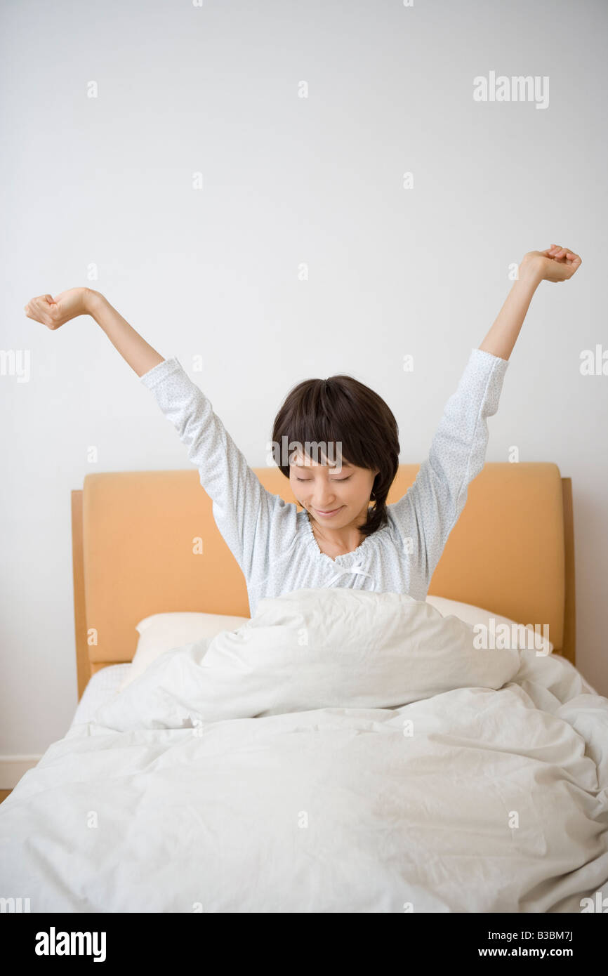Asian woman waking up stretching hi-res stock photography and images ...
