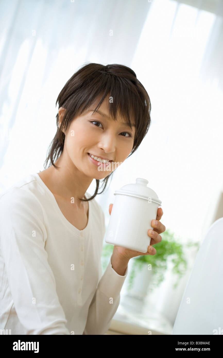 Young woman holding jar Stock Photo - Alamy