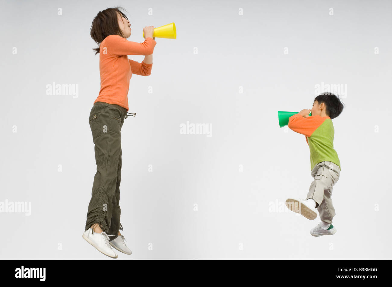 Mother and son shouting with megaphone Stock Photo - Alamy