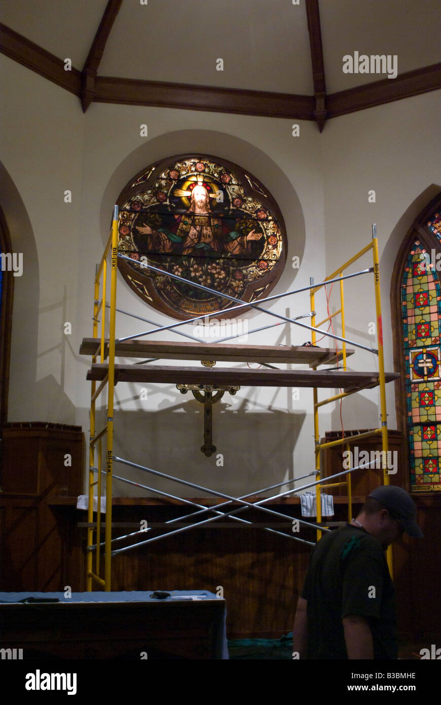A worker surveys scaffolding set up to repair this christian stained ...