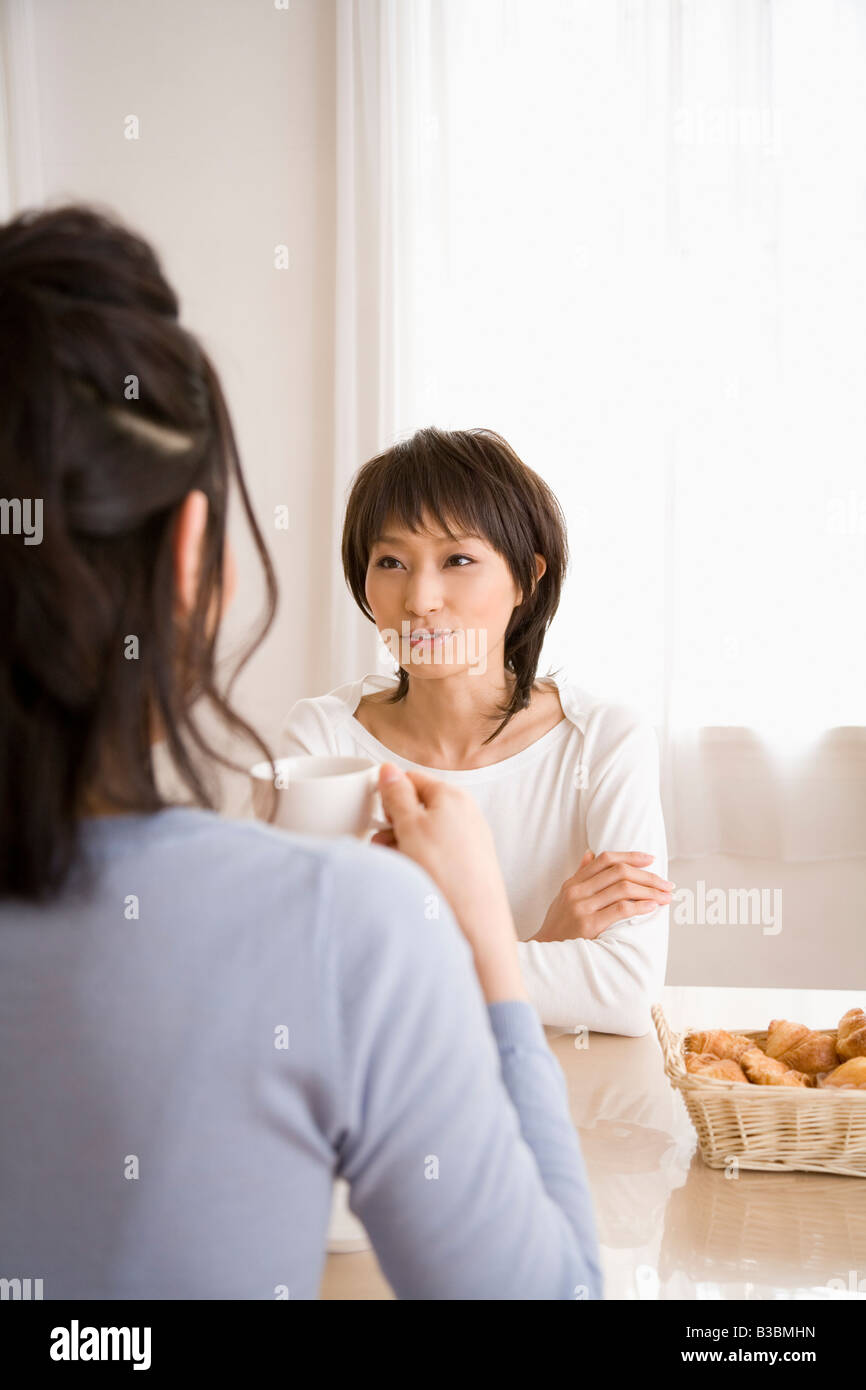 Young women drinking tea Stock Photo - Alamy