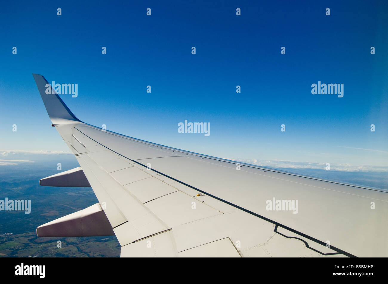 Looking out an aircraft window at the wing of a boeing 737 800 at a ...