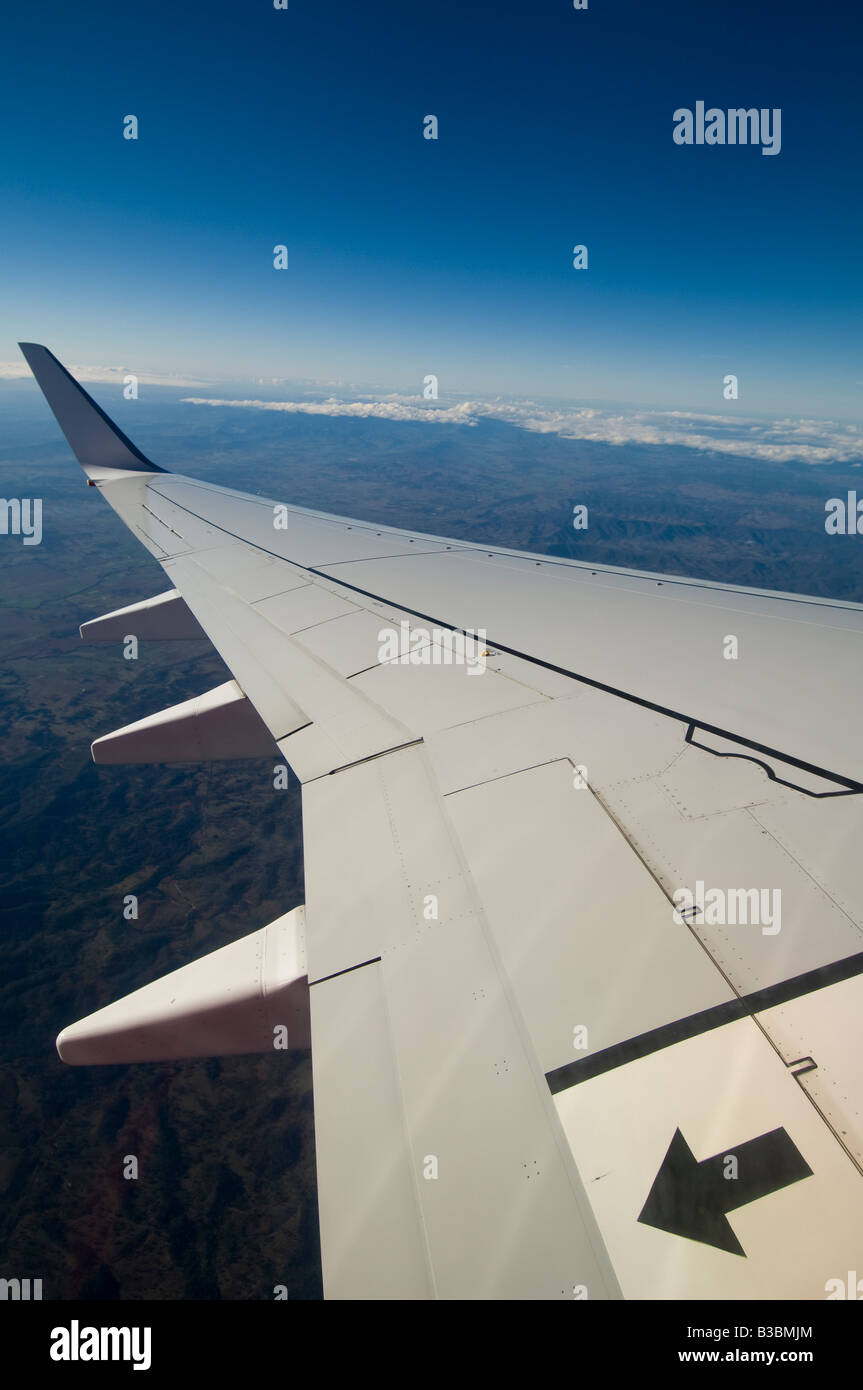 Looking out an aircraft window at the wing of a boeing 737 800 at a ...