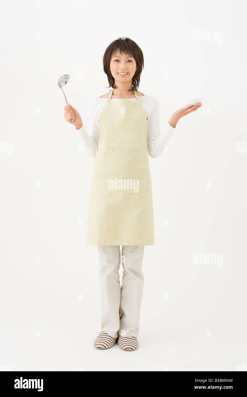 Young woman holding ladle Stock Photo - Alamy