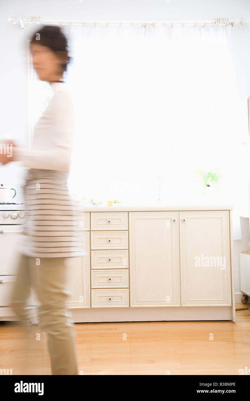 Woman walking kitchen hi-res stock photography and images - Alamy