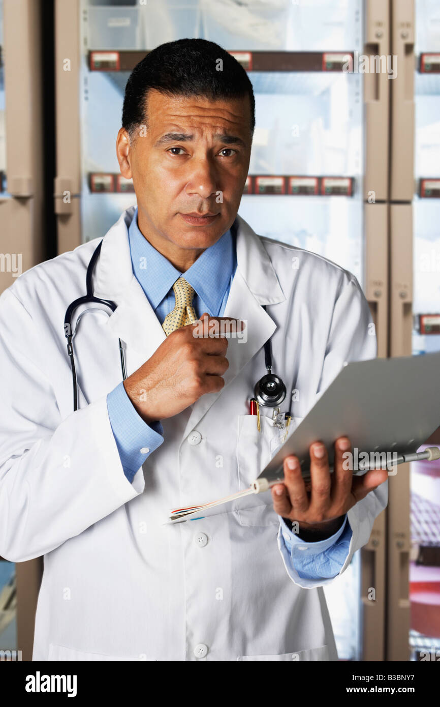African male doctor holding chart Stock Photo - Alamy