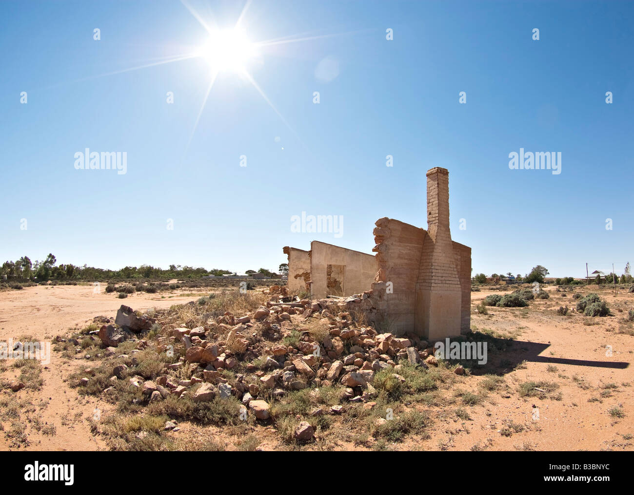 old rubble and ruins of a stone building in the hot sun of the desert ...