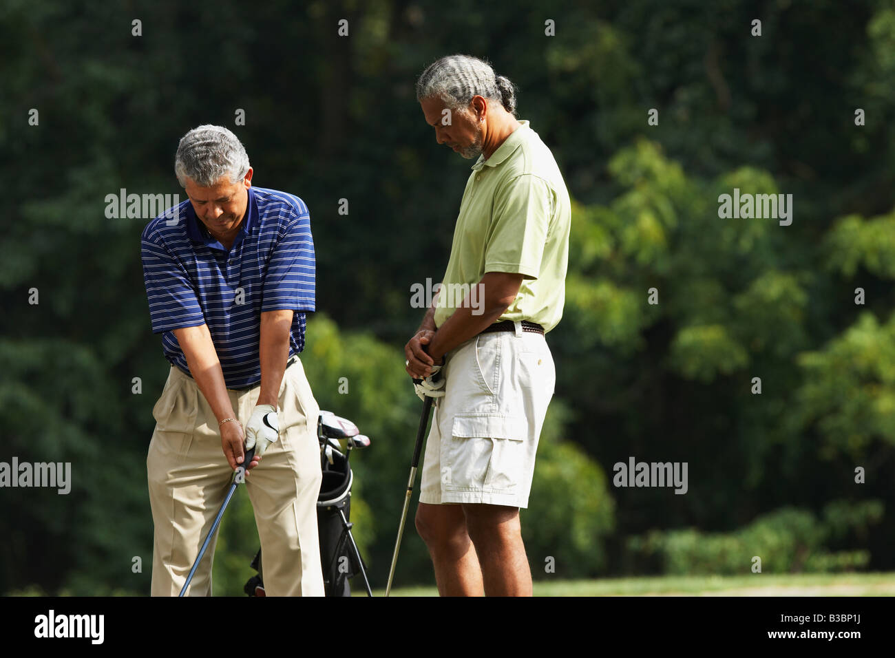 Multi-ethnic men playing golf Stock Photo - Alamy