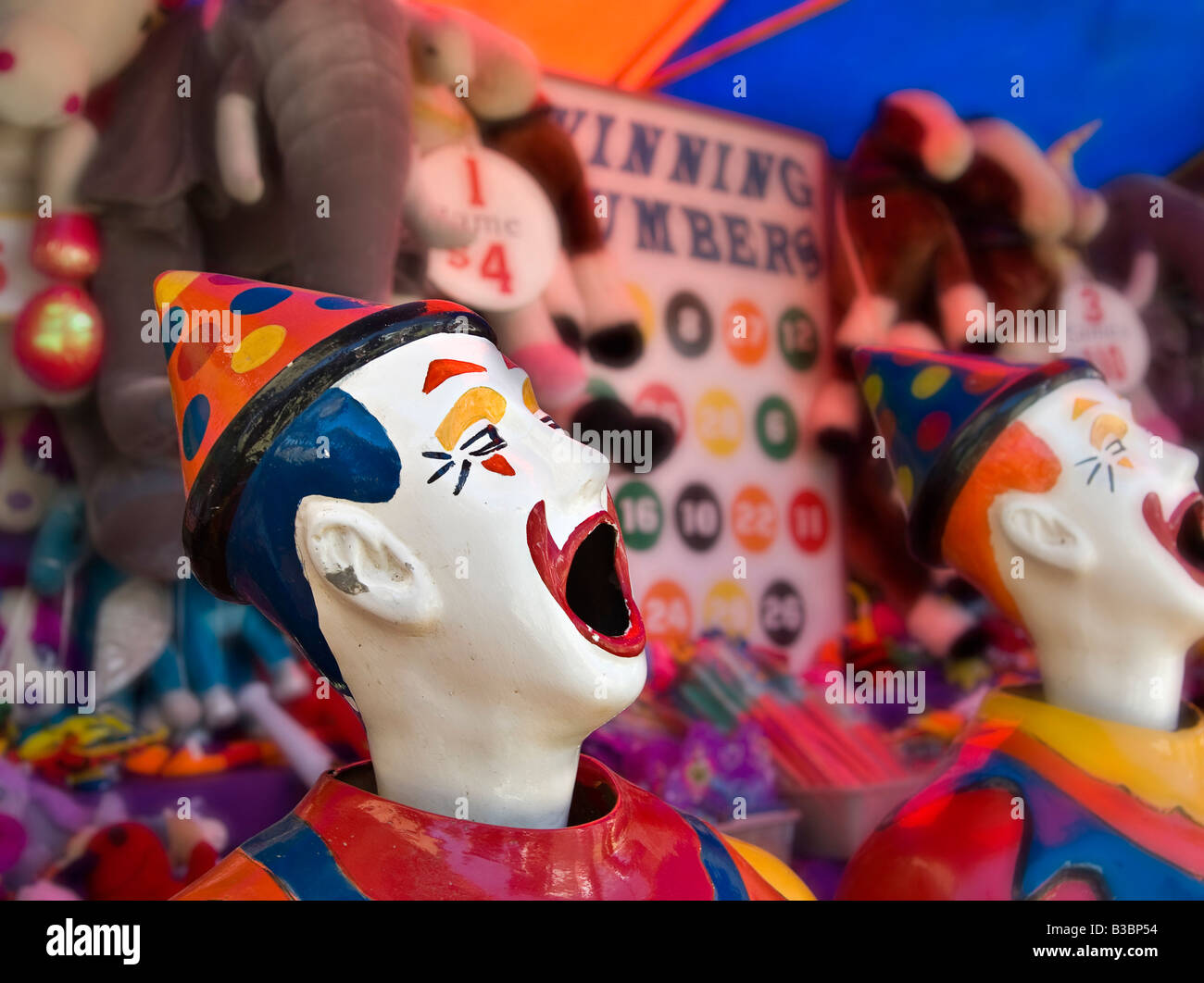 sideshow clowns with big mouths at the funfair Stock Photo - Alamy