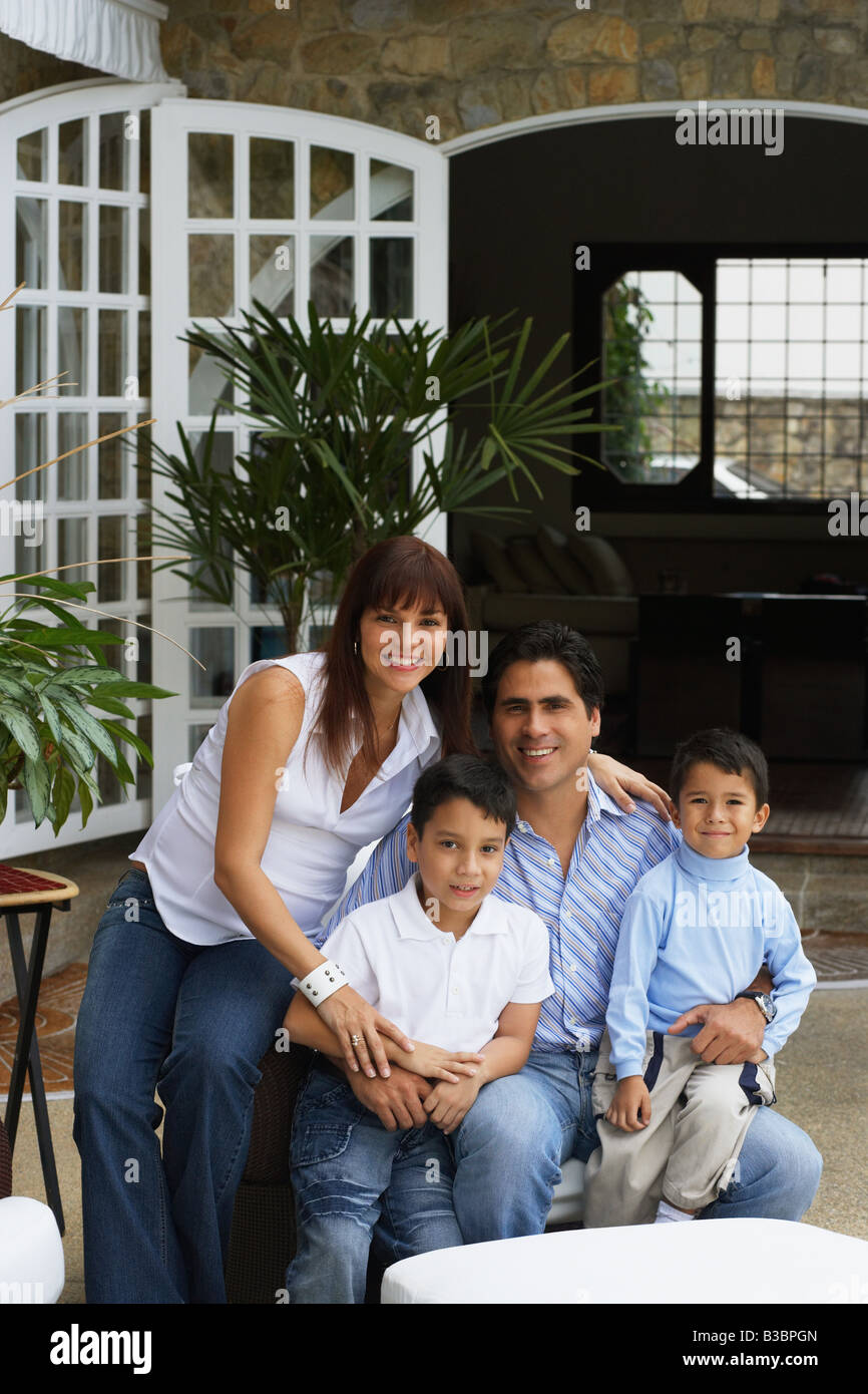 Hispanic family sitting on patio Stock Photo - Alamy