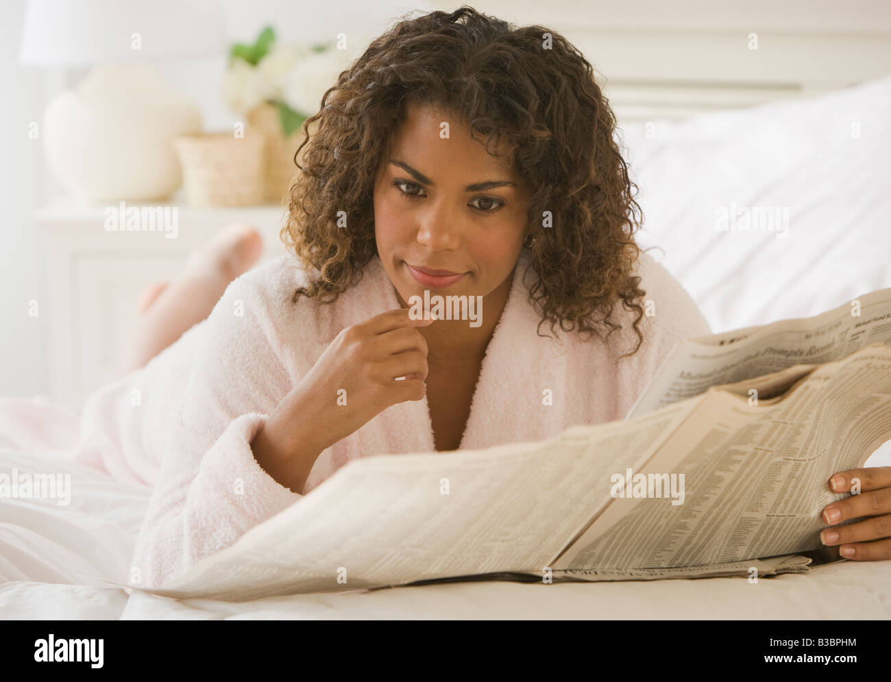 African woman reading newspaper Stock Photo - Alamy