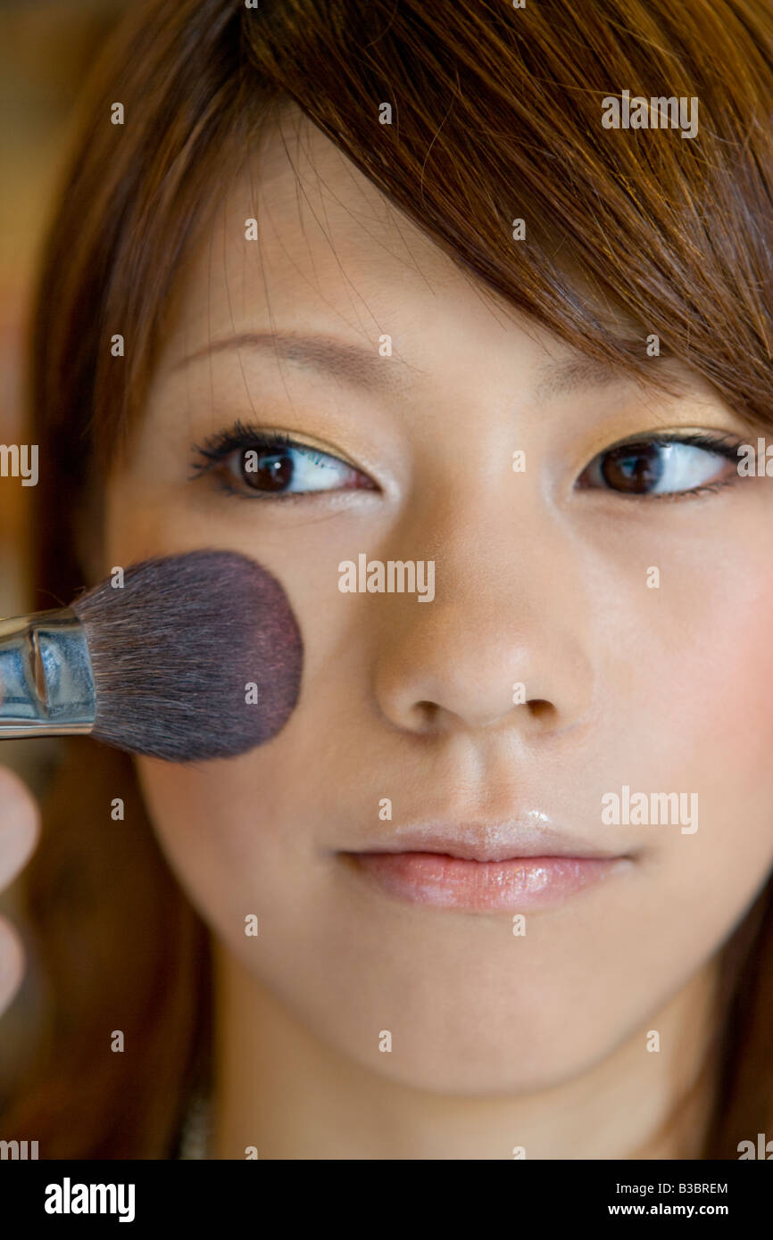 Young woman applying make up Stock Photo - Alamy